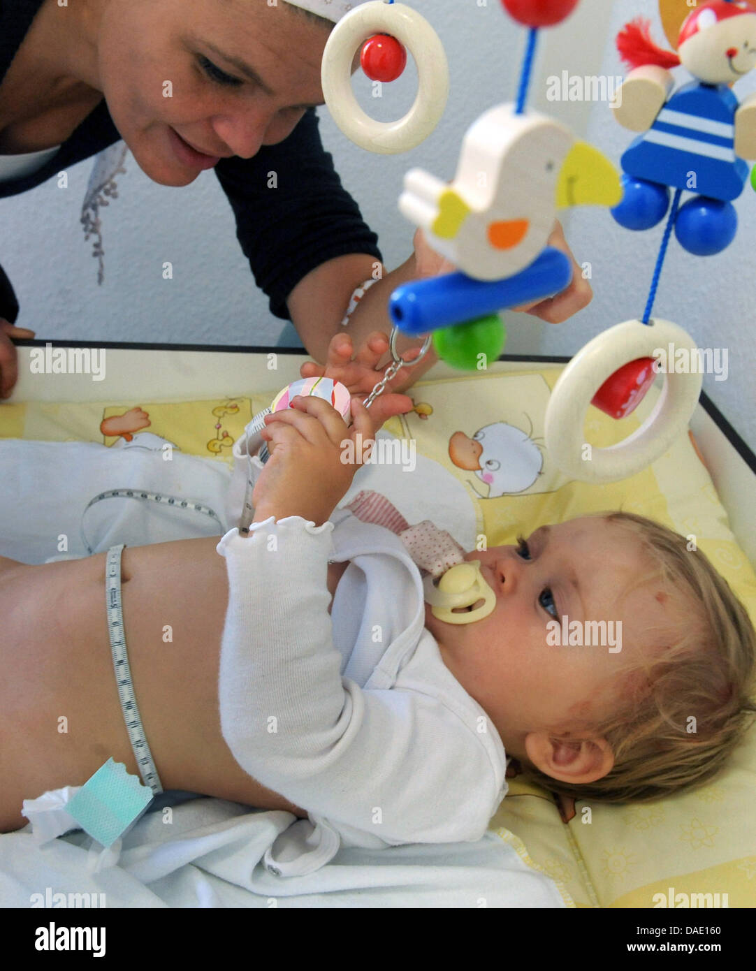 A mother watches her one-year-old child at the ambulatory care unit of ...