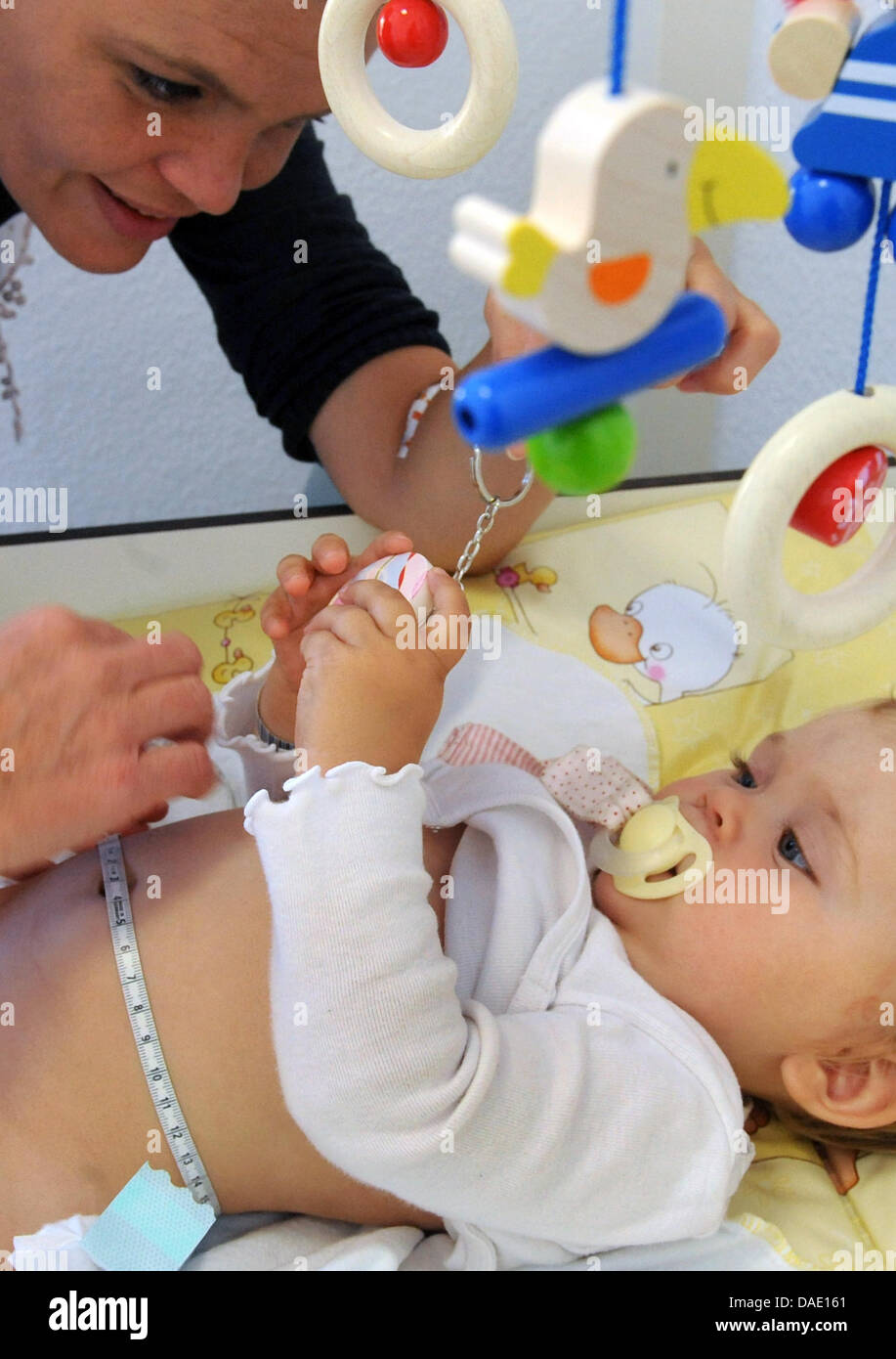 A mother watches a one-year-old child at the ambulatory care unit of ...