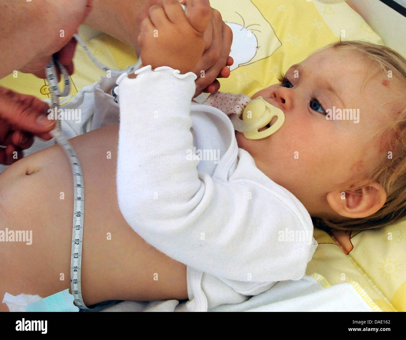 A mother watches her one-year-old child at the ambulatory care unit of ...
