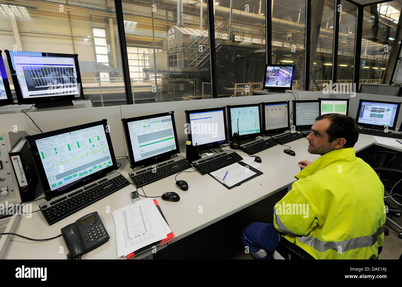 An employee of the Classen factory surveys production of MDF sheets in ...