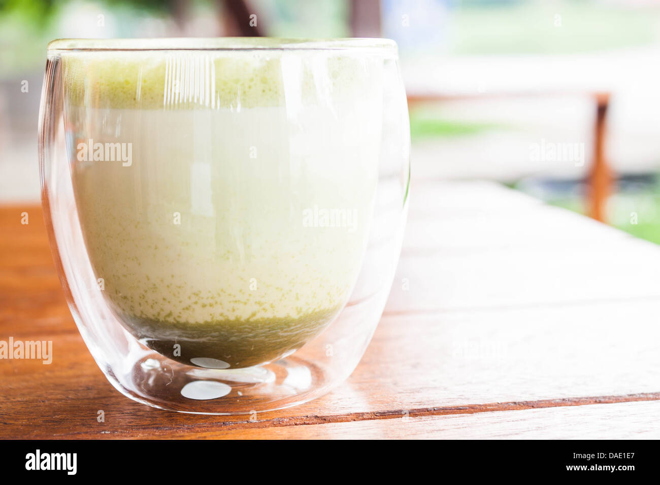 Glass of hot matcha green tea latte at coffee shop Stock Photo - Alamy