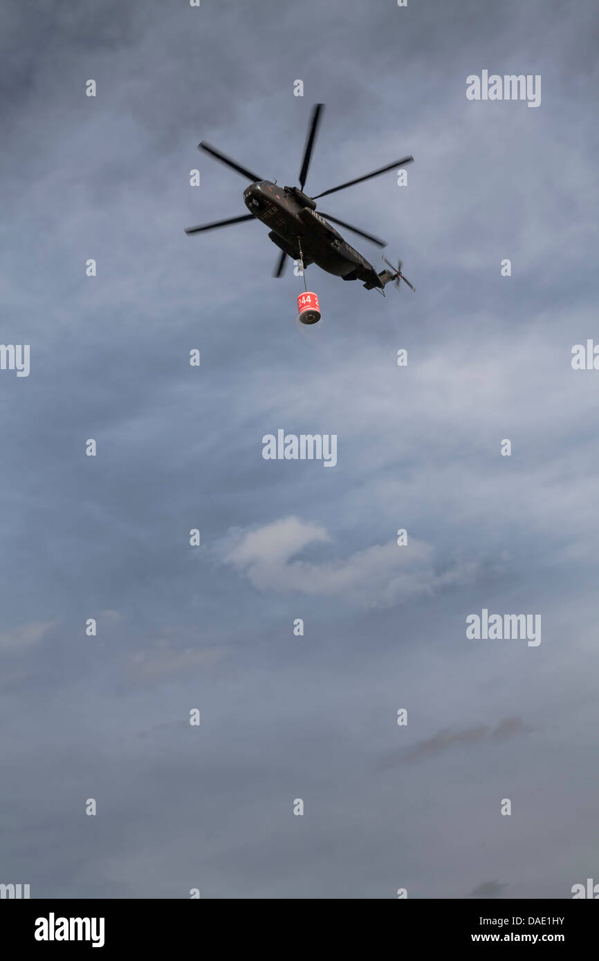 Germany, Laupheim, German CH-53 helicopter flying in air with water ...