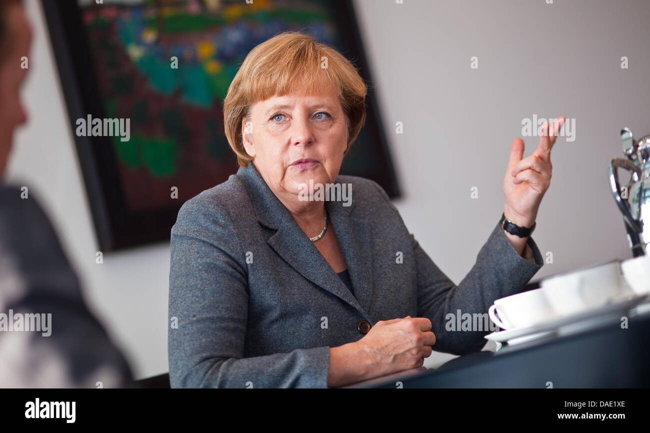 German Chancellor Angela Merkel speaks during an interview with the ...