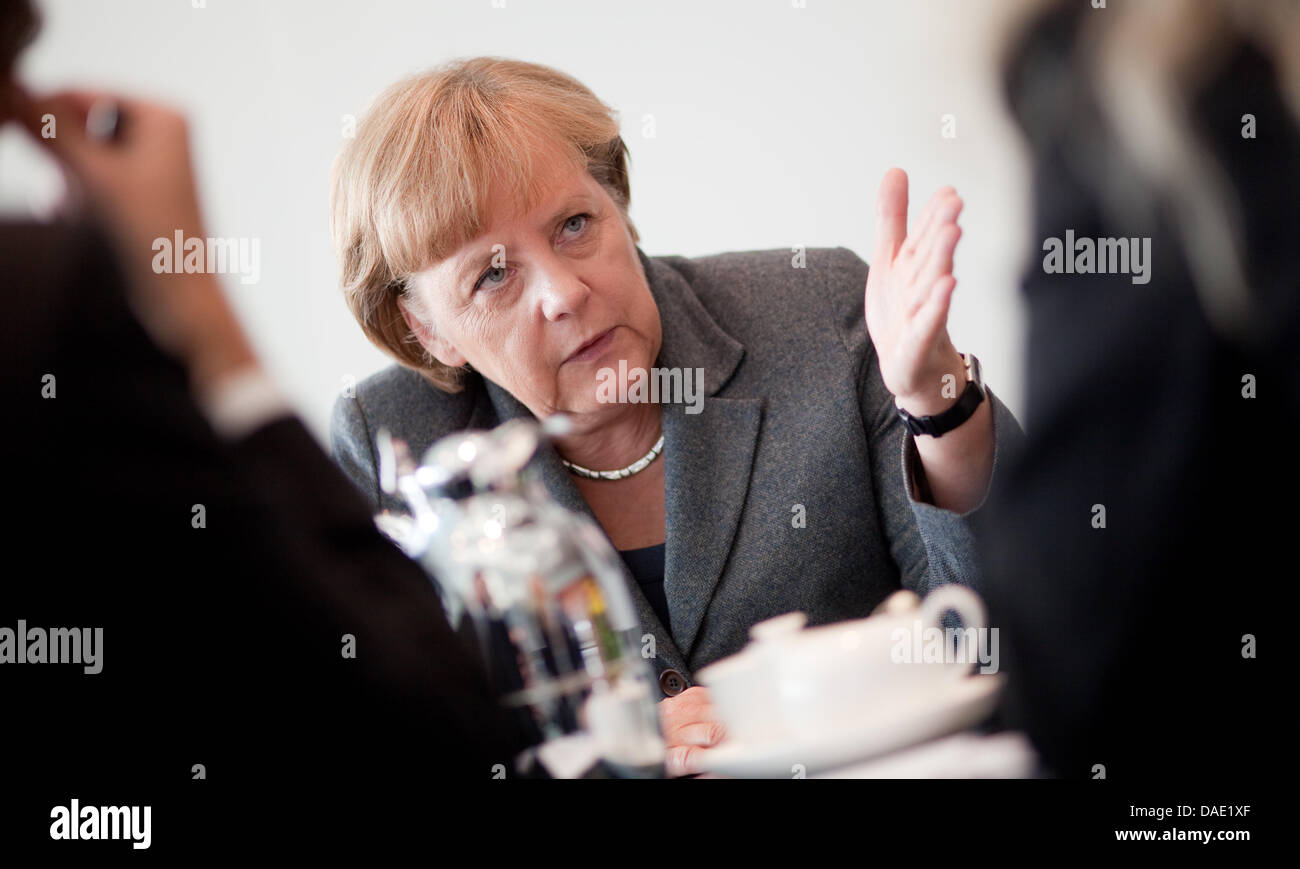 German Chancellor Angela Merkel speaks during an interview with the ...