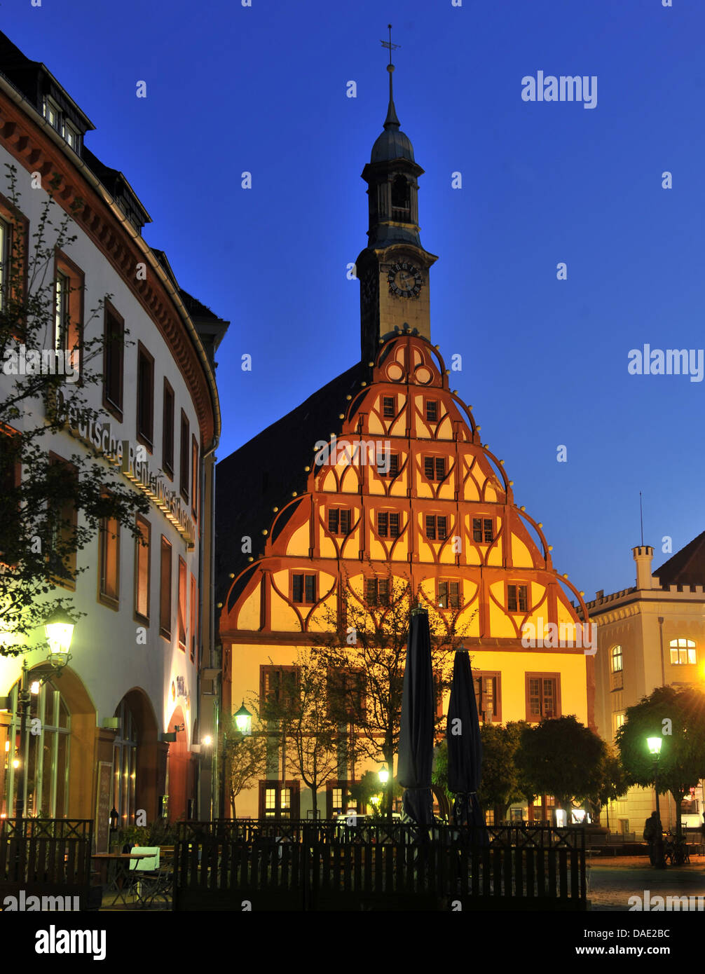 The illuminated guild hall with its characteristic crowstepped roof is ...