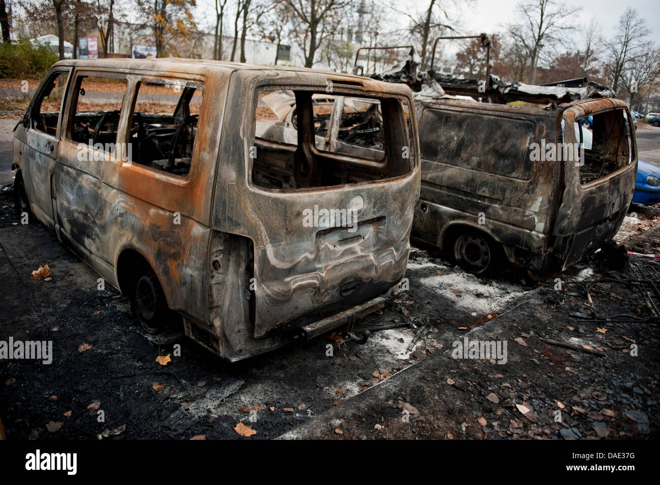 Two burnt out cars hit by an arson attack stand on a car park in Berlin ...