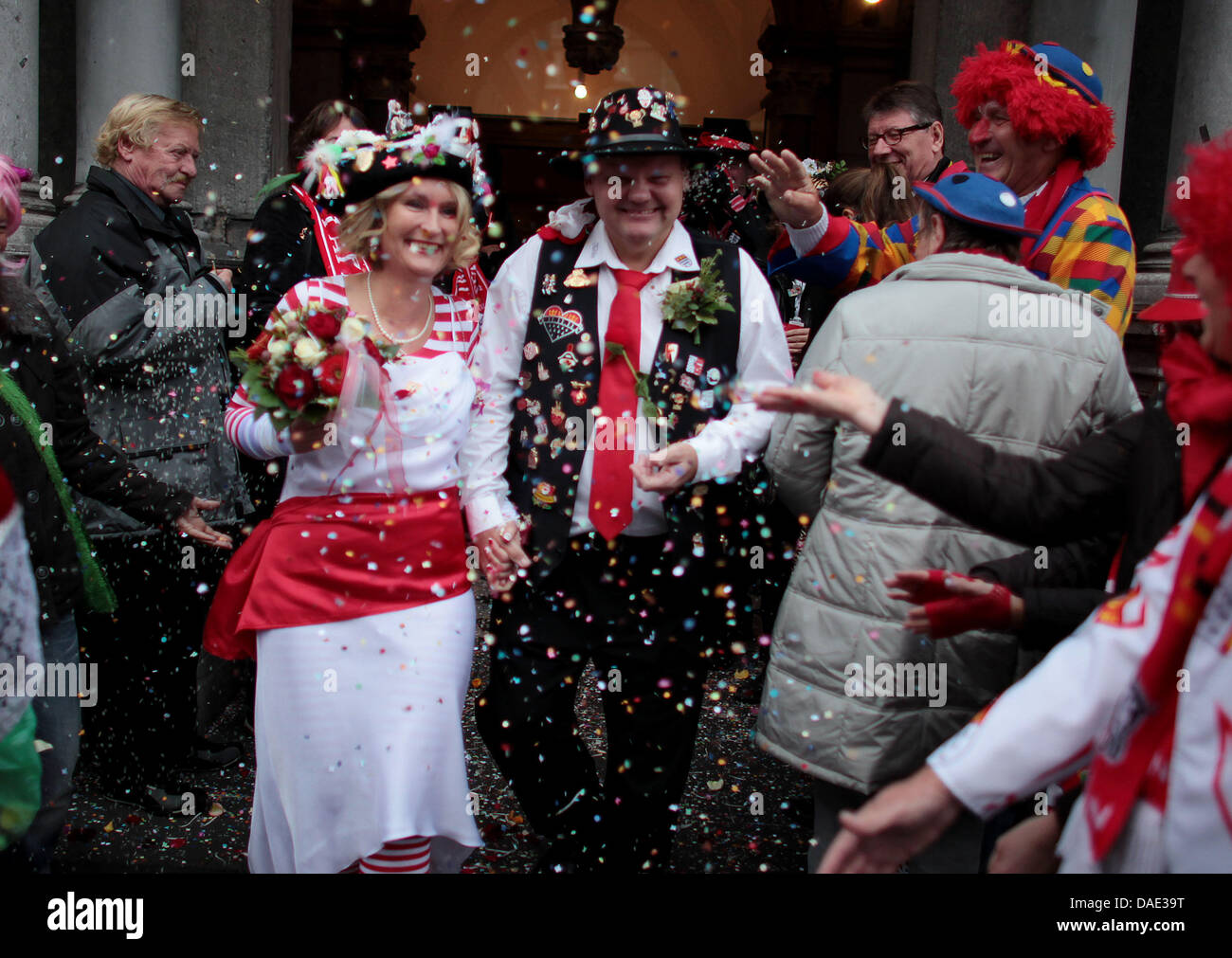 A wedding couple is welcomed with confetti after their marriage in the ...