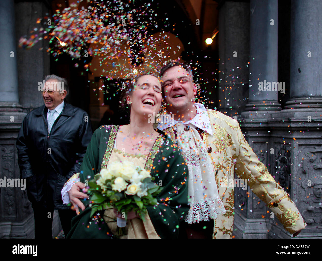 A wedding couple is welcomed with confetti after their marriage in the ...