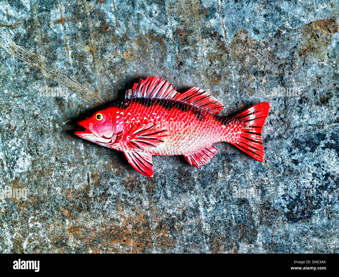 Toy fish on rusty background, close up Stock Photo - Alamy