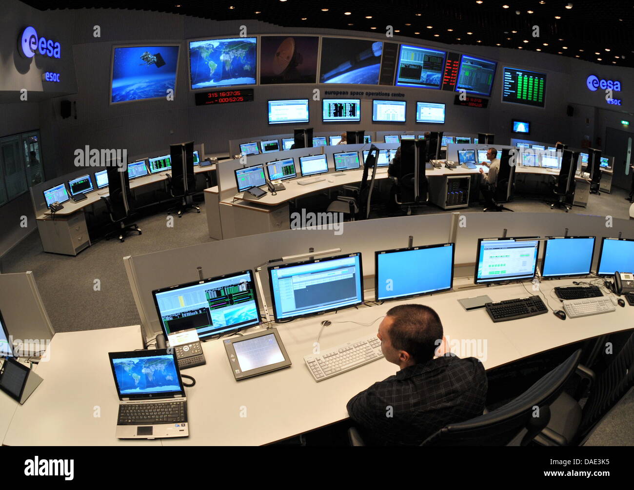 ESA staff monitor the computer screens in front of them in the newly ...