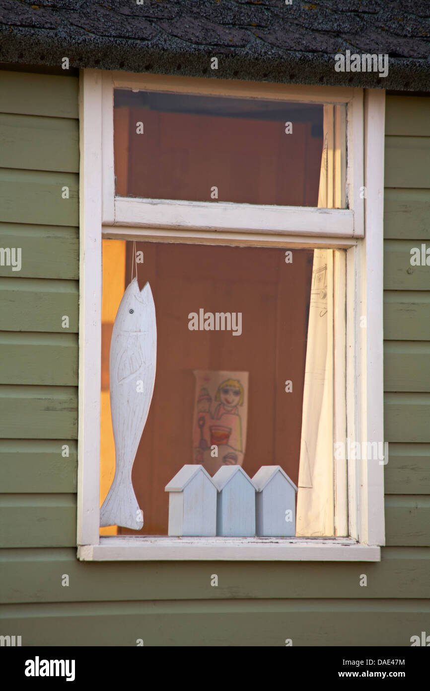 model beach huts and hanging fish on display in window of beach hut at ...