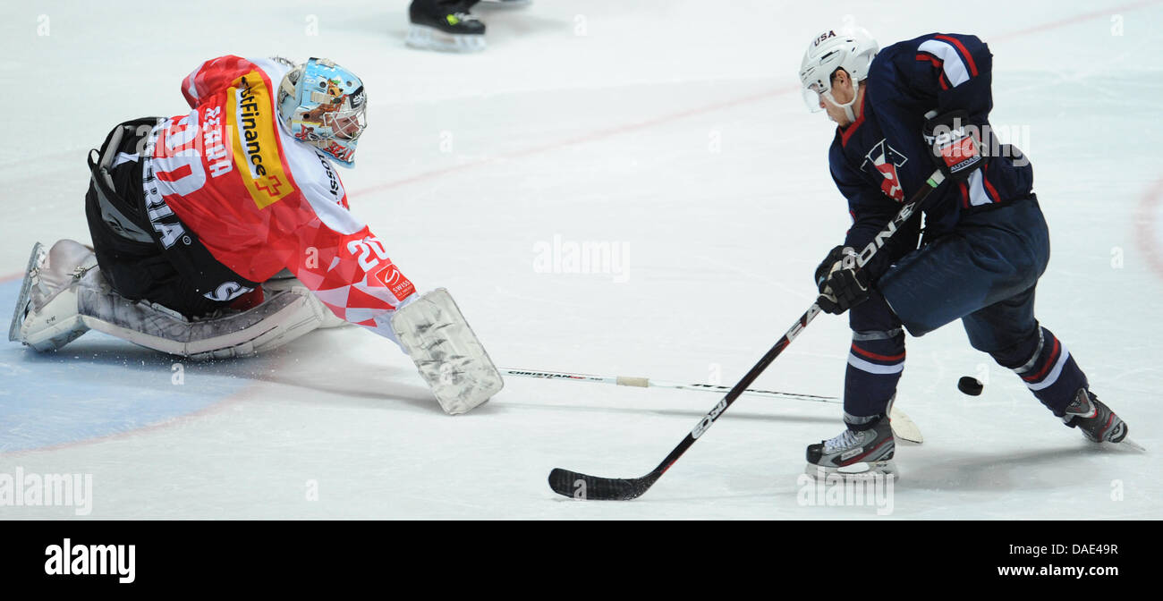 Swiss goalkeeper Reto Berra (L) parades the penatly shot of US hockey ...