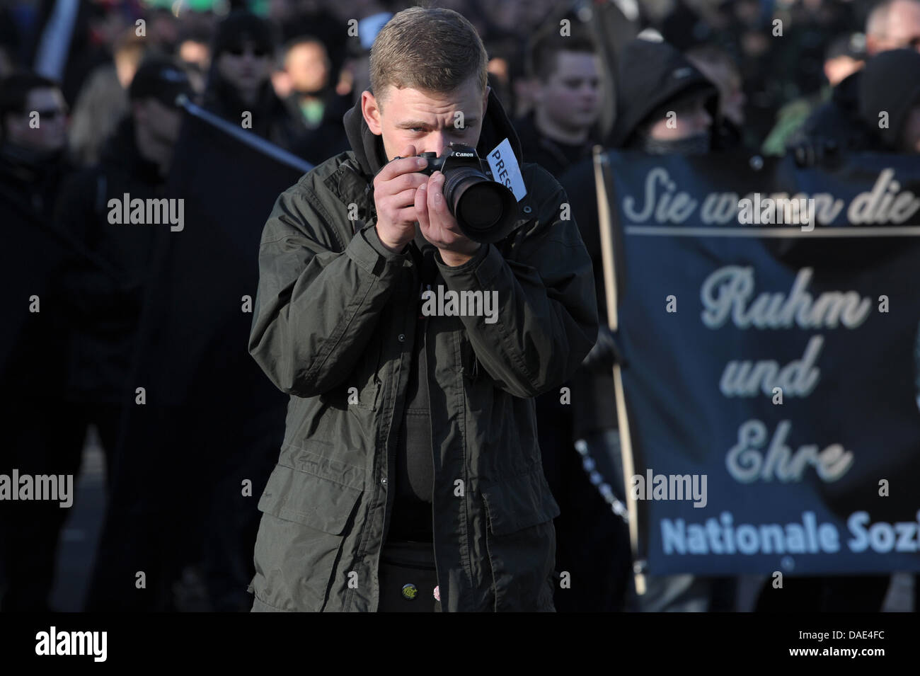 A participant of a neo-Nazi demonstration wearing the sign 'press' on ...