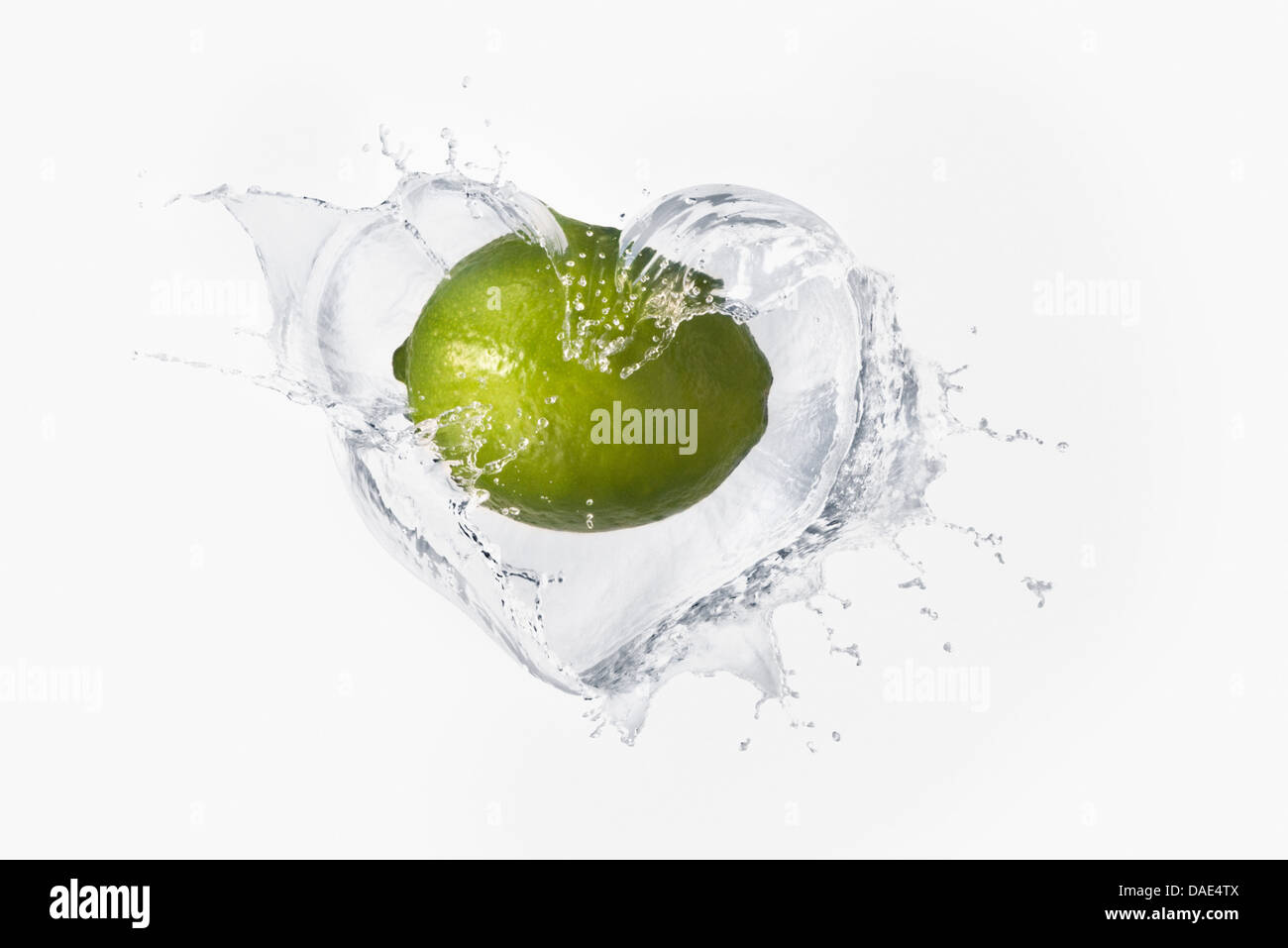 Lime splashing in liquid Stock Photo - Alamy