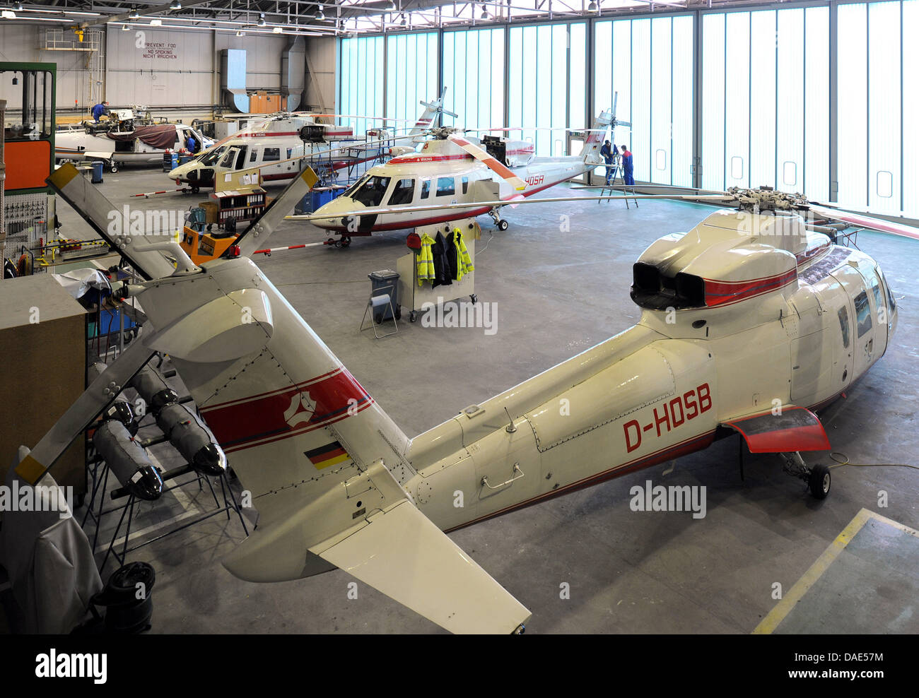 Wiking Helikopter Service employees work inside the company's hangar in ...