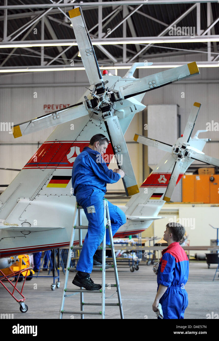 Wiking Helikopter Service employees work inside the company's hangar in ...