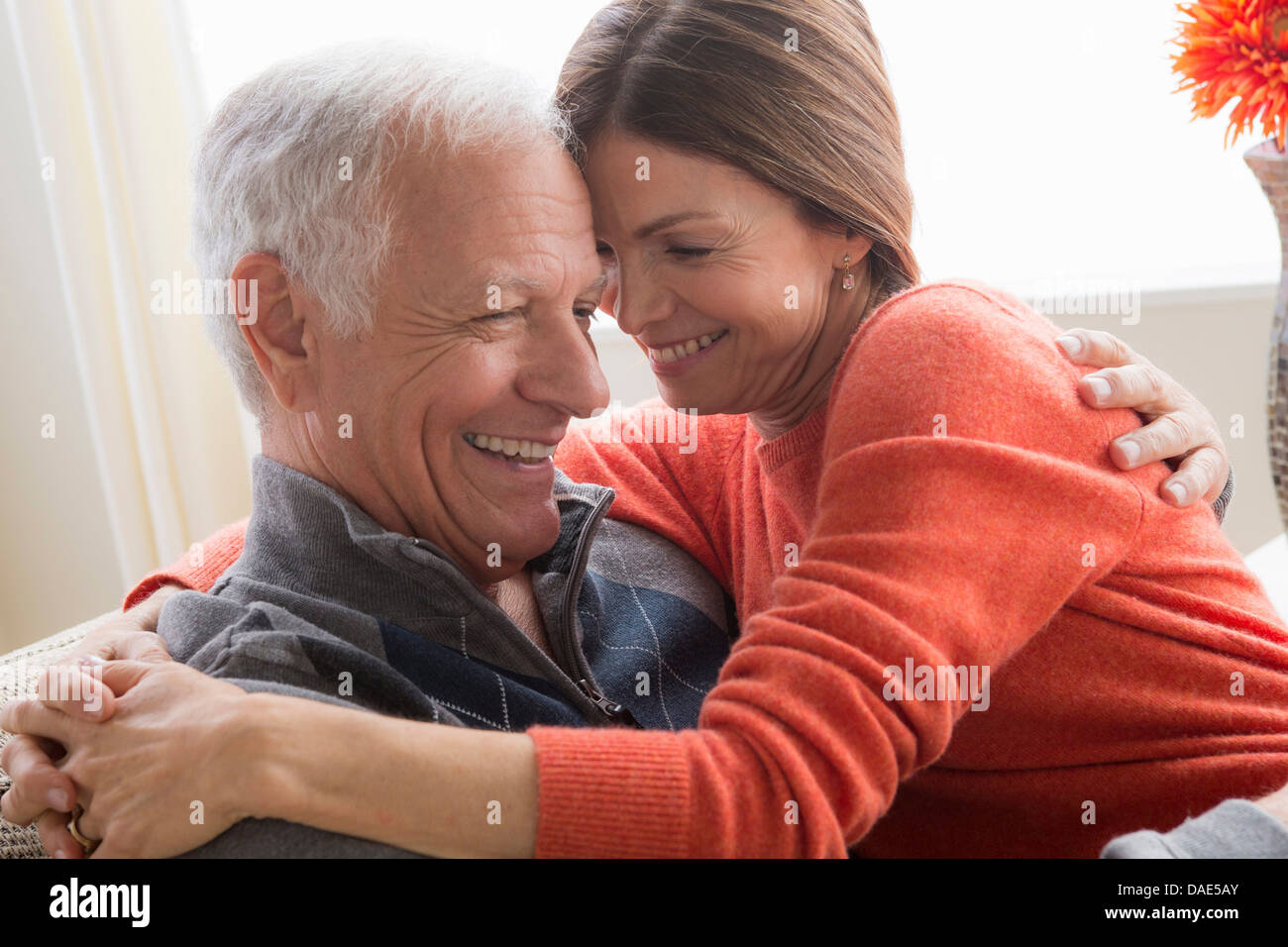 Mature woman and senior man hugging Stock Photo - Alamy