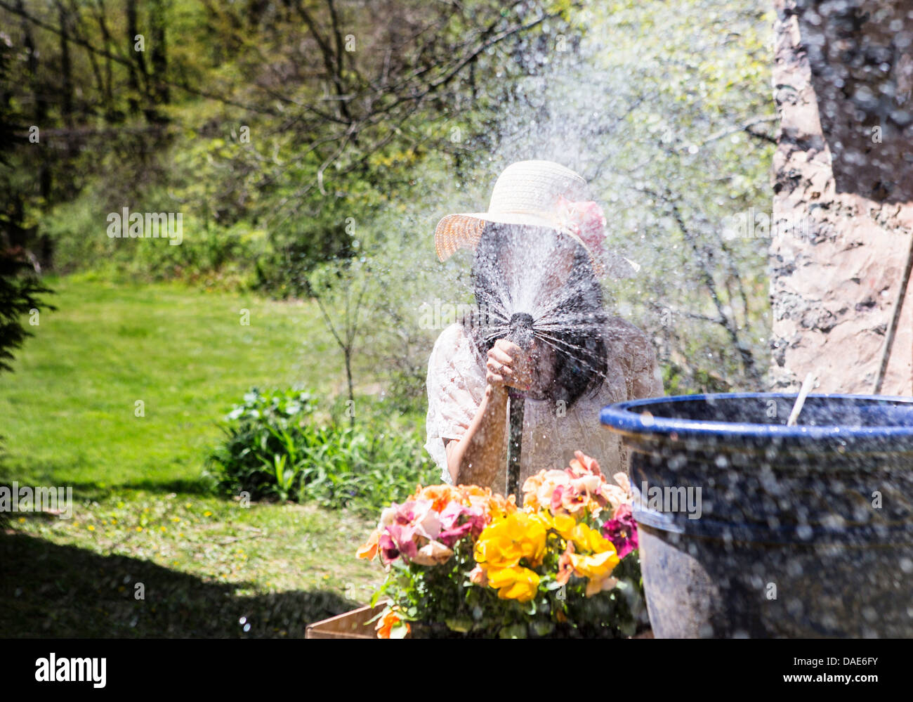 Woman spraying water hi-res stock photography and images - Alamy