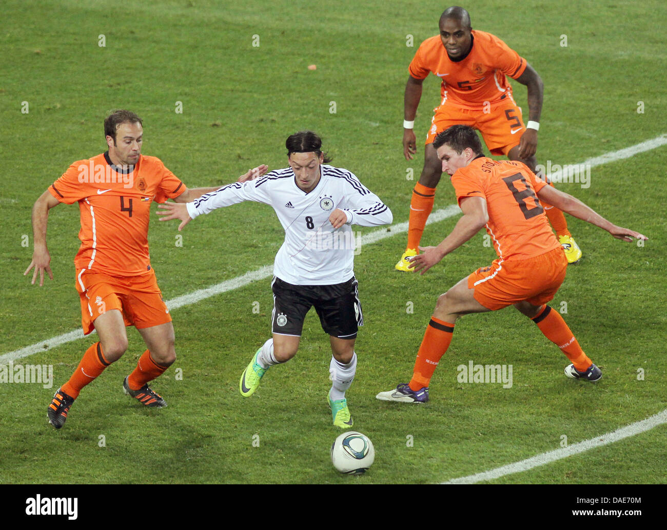 Germany's Mesut Özil (M) and Dutch Joris Mathijsen (L-R), Edson ...