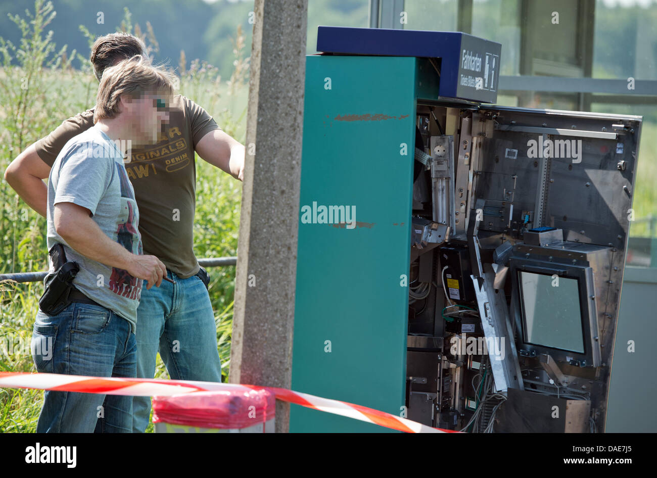 Police officers inspect an exploded railyway ticket vending machine on ...