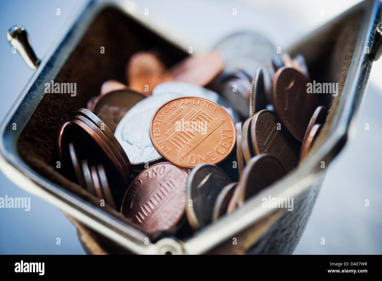 Purse filled with coins Stock Photo - Alamy