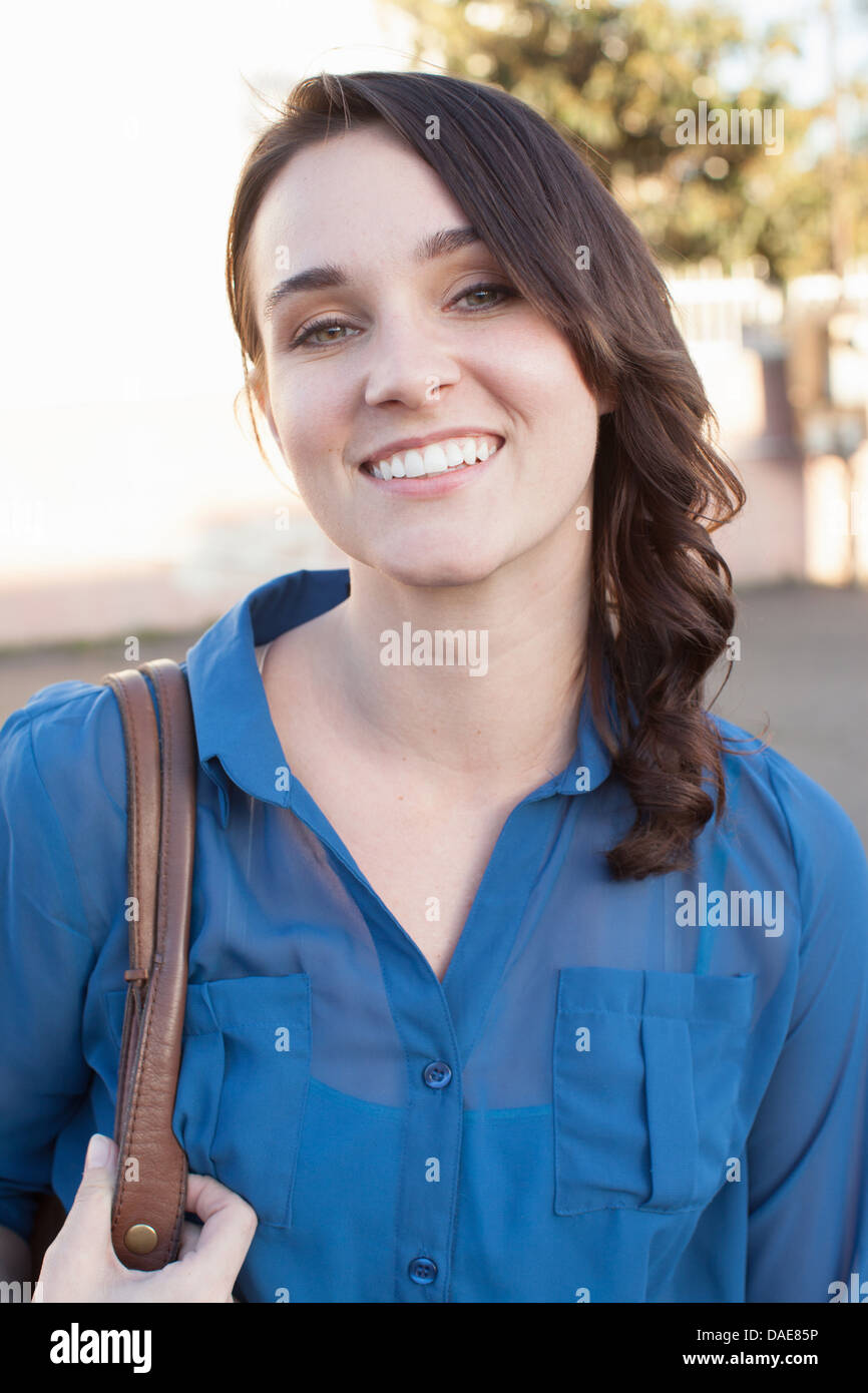 Portrait of young woman wearing blue blouse Stock Photo - Alamy