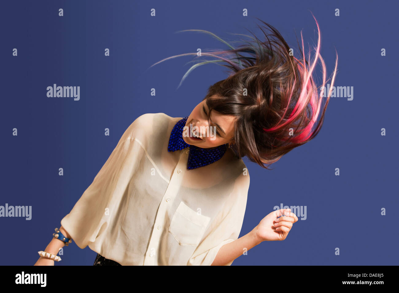 Portrait of young woman with dyed hair dancing Stock Photo - Alamy