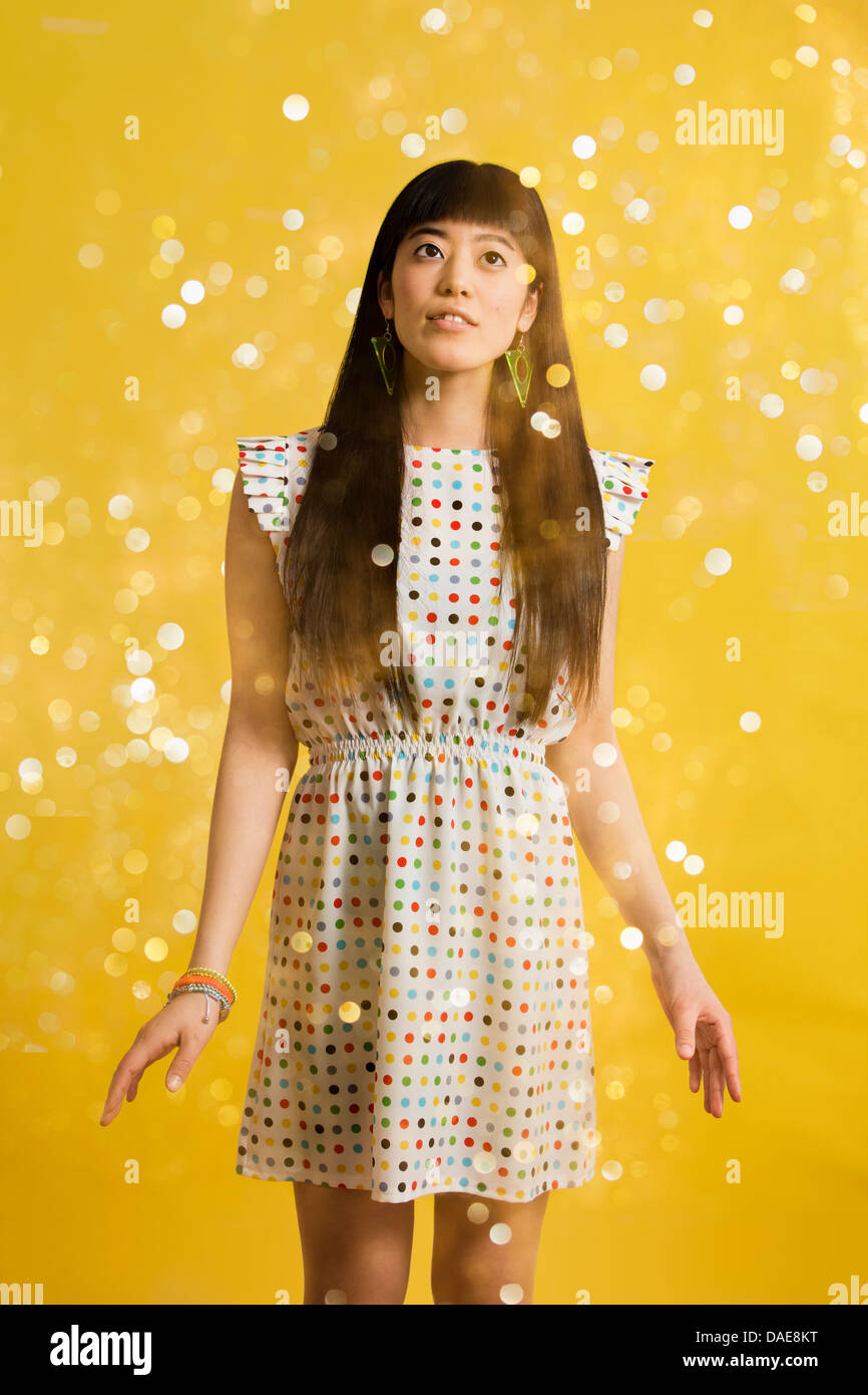 Portrait of young woman wearing spotted dress with glitter Stock Photo ...