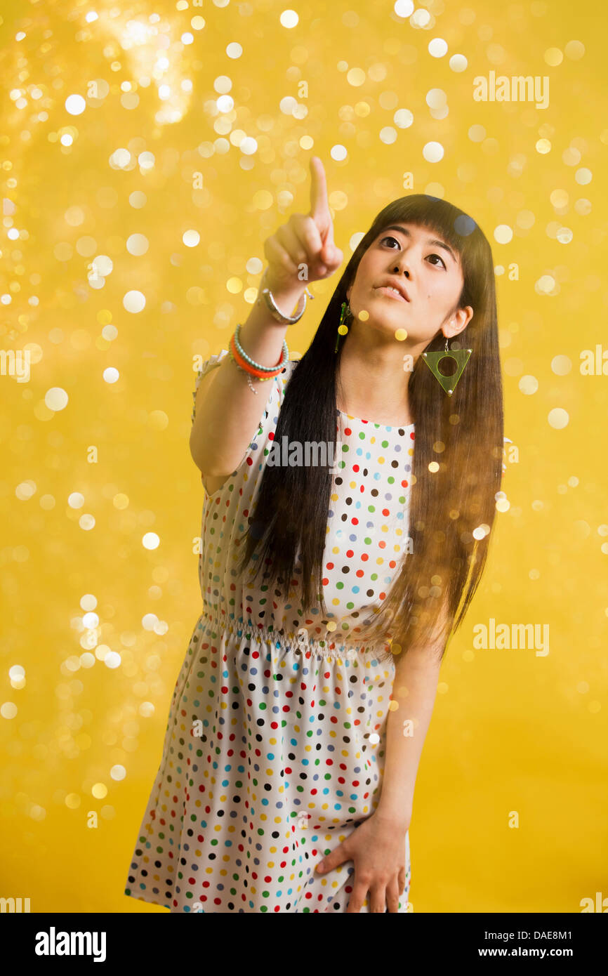 Portrait of young woman wearing spotted dress with glitter Stock Photo ...