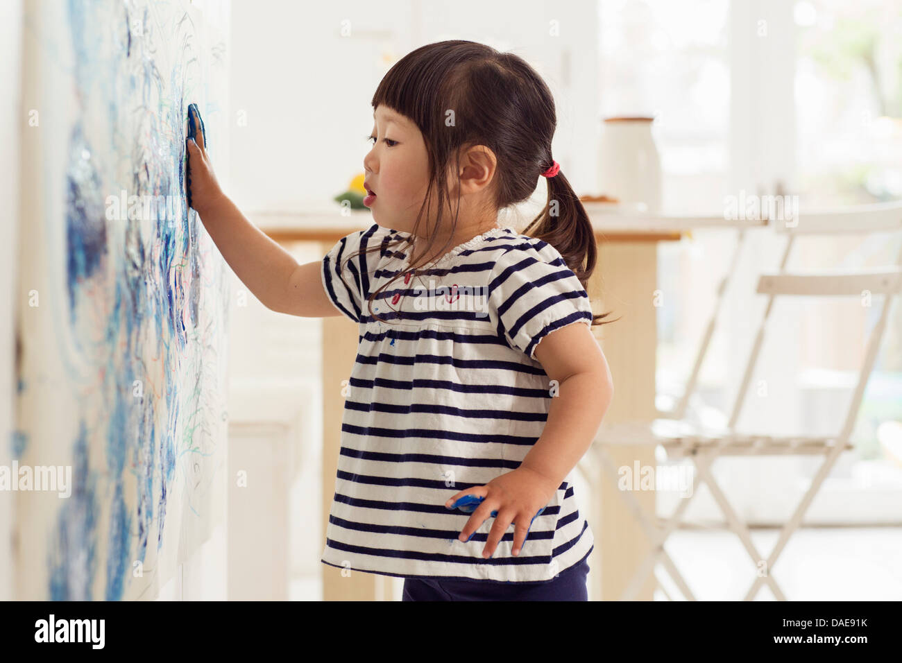 Female toddler making handprint painting Stock Photo - Alamy