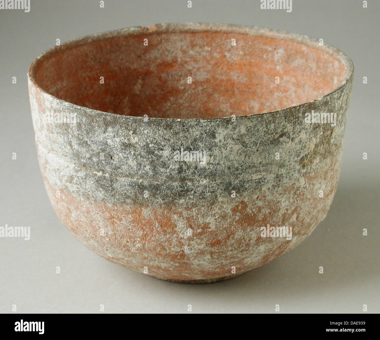 This bowl, crafted from black-topped ware, is a piece of ancient ...