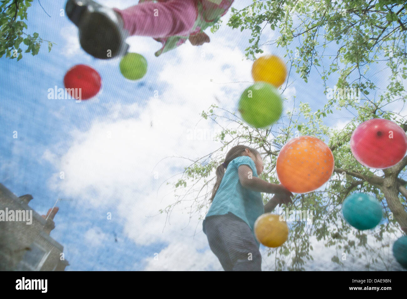 Young girls jumping on garden trampoline Stock Photo - Alamy