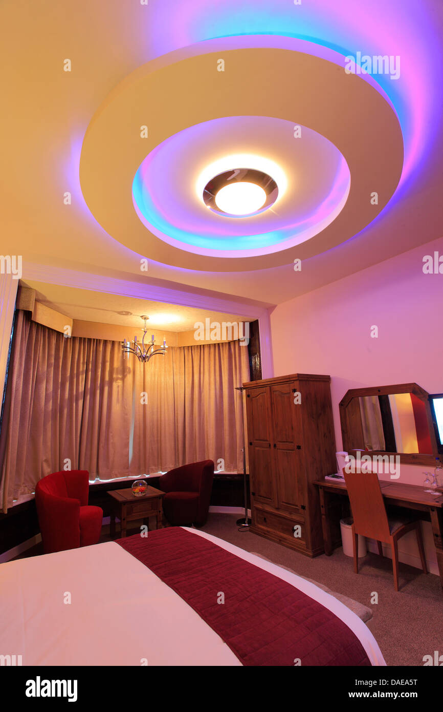 Interior of a Hotel Bedroom with ceiling lights, double bed and soft ...