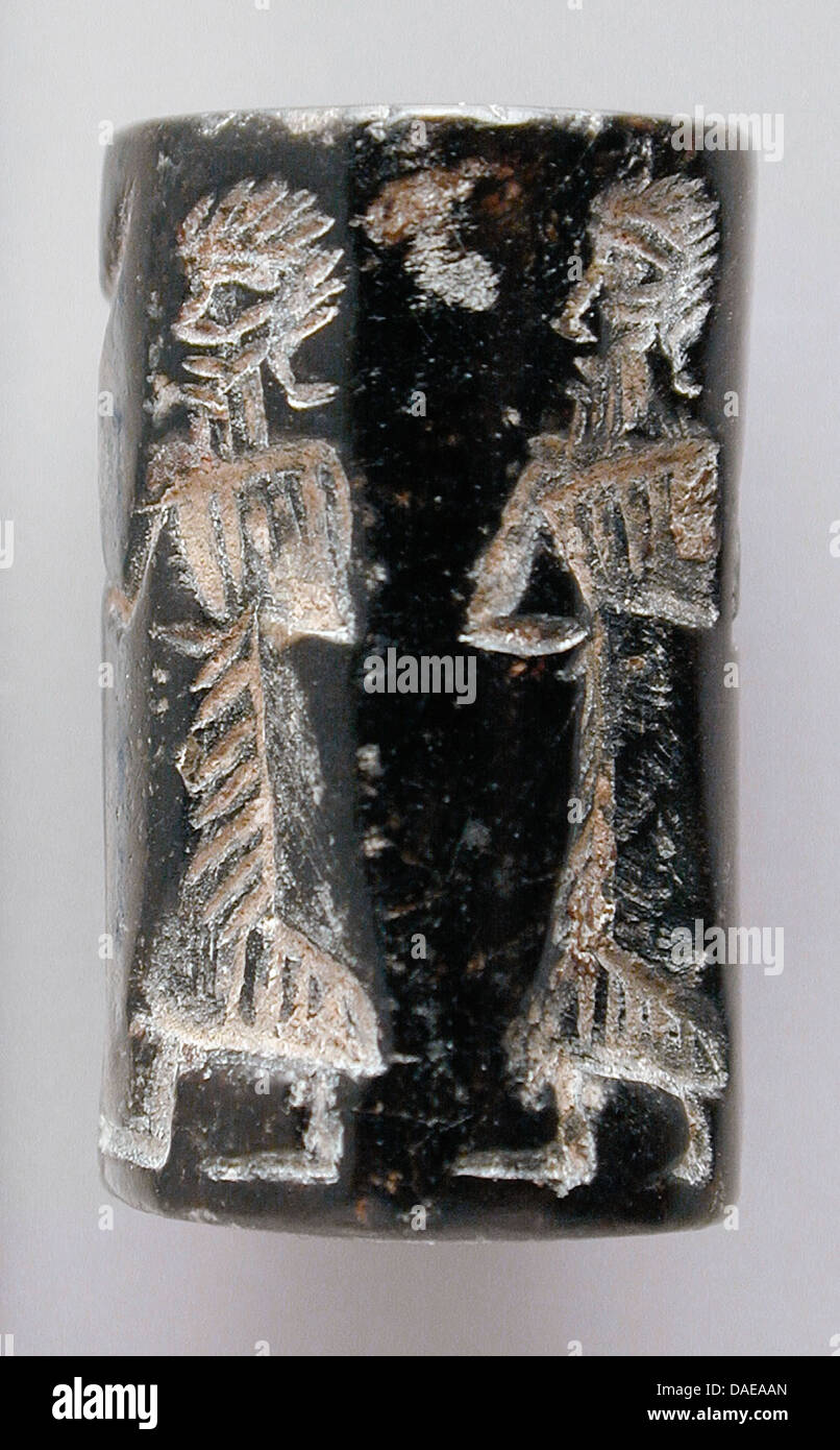 This cylinder seal features detailed carvings of ancient motifs ...