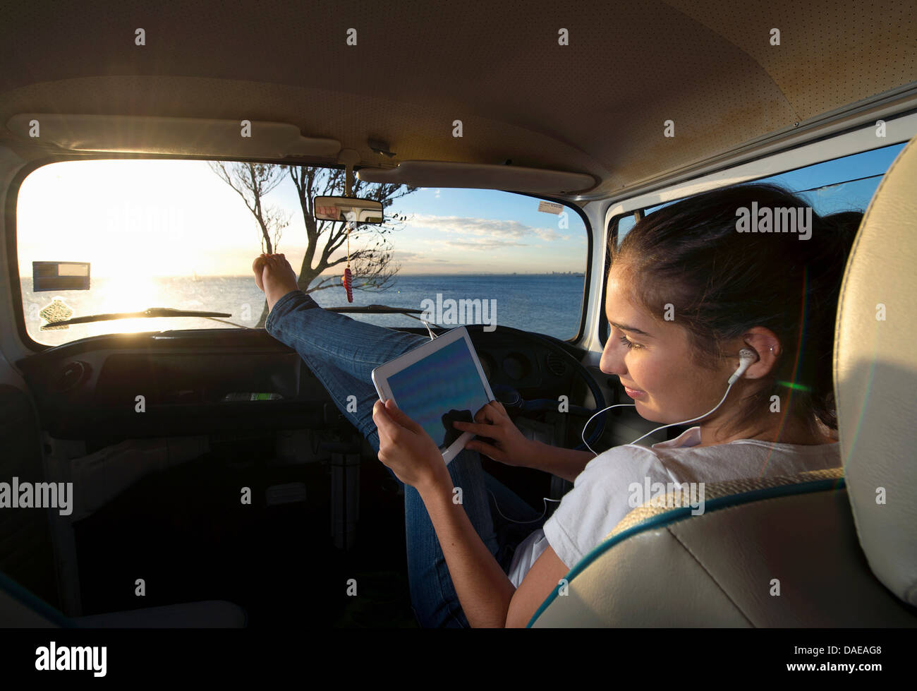 Young woman in camper van using digital tablet Stock Photo - Alamy