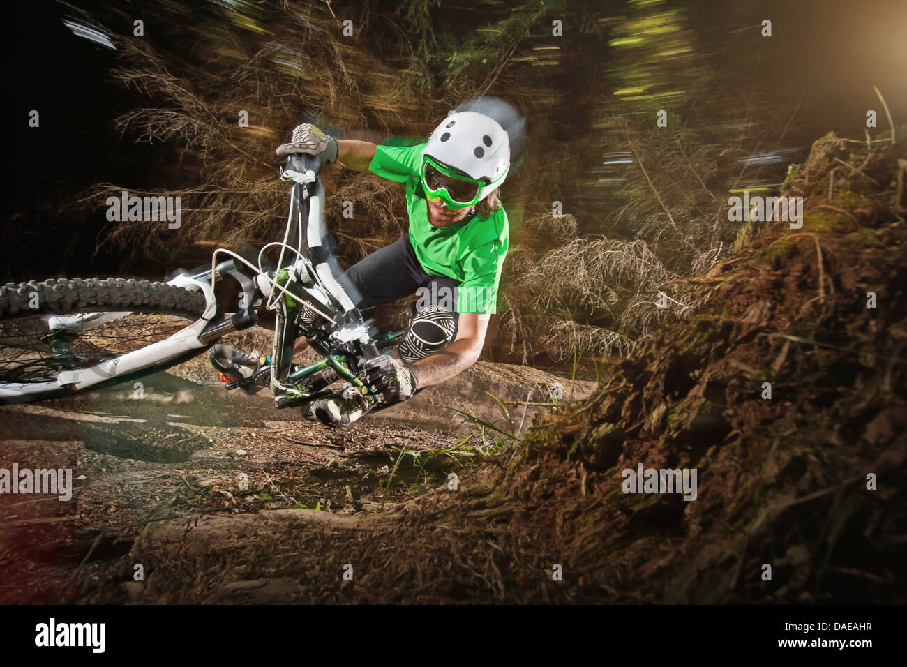 Mountain biker riding narrow track Stock Photo - Alamy