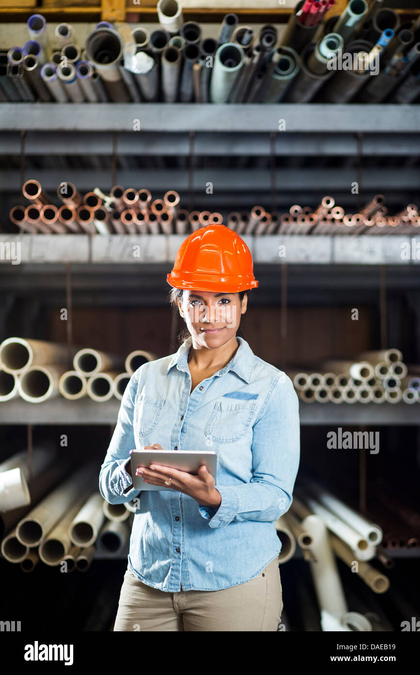 Woman in warehouse with digital tablet Stock Photo - Alamy