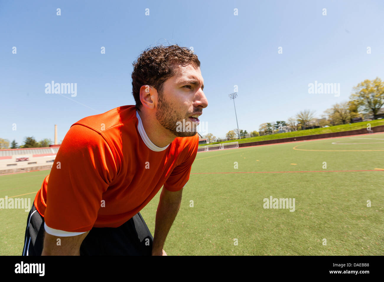 Soccer player taking a break on pitch Stock Photo - Alamy