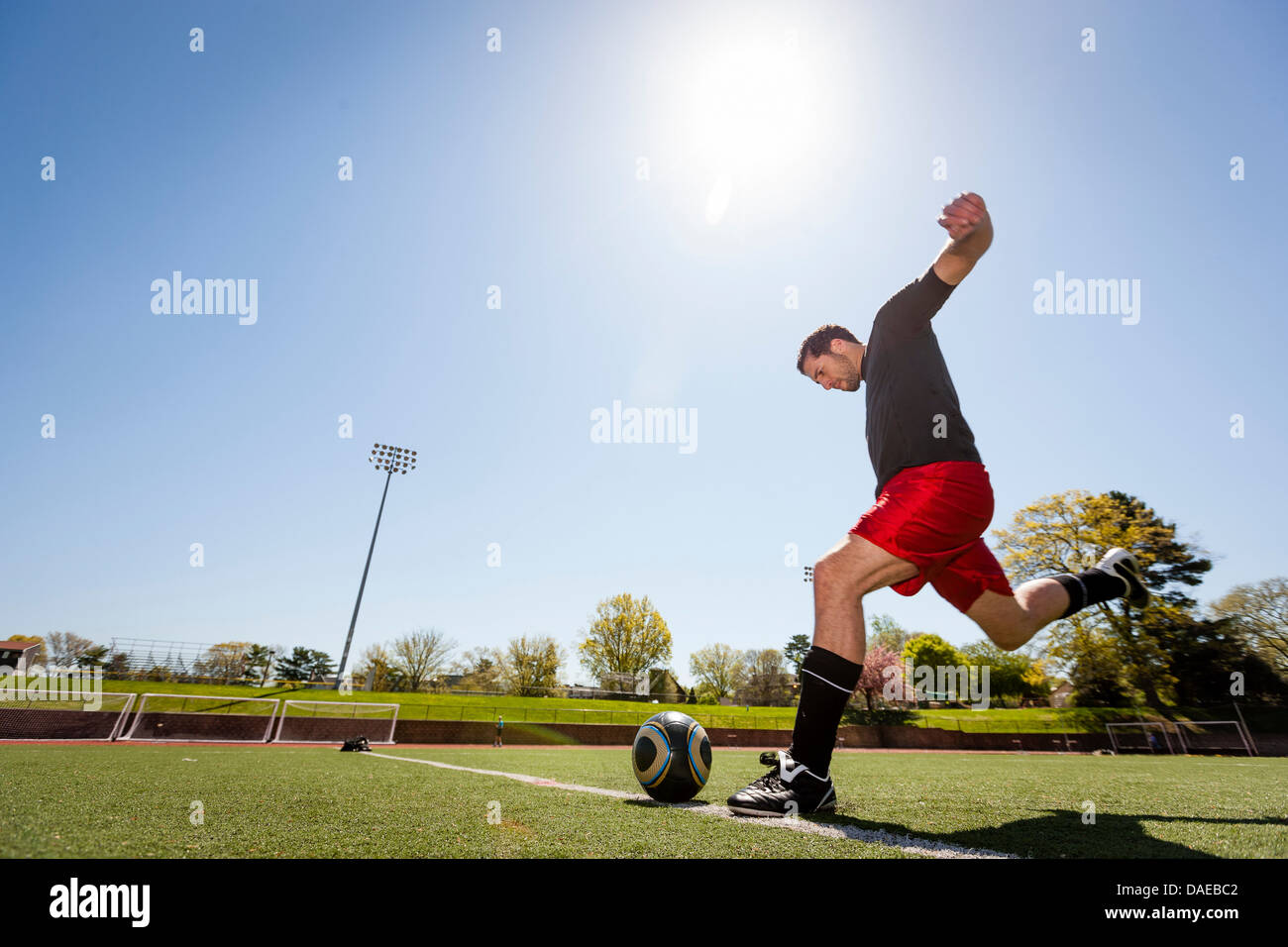 Soccer player taking free kick Stock Photo - Alamy