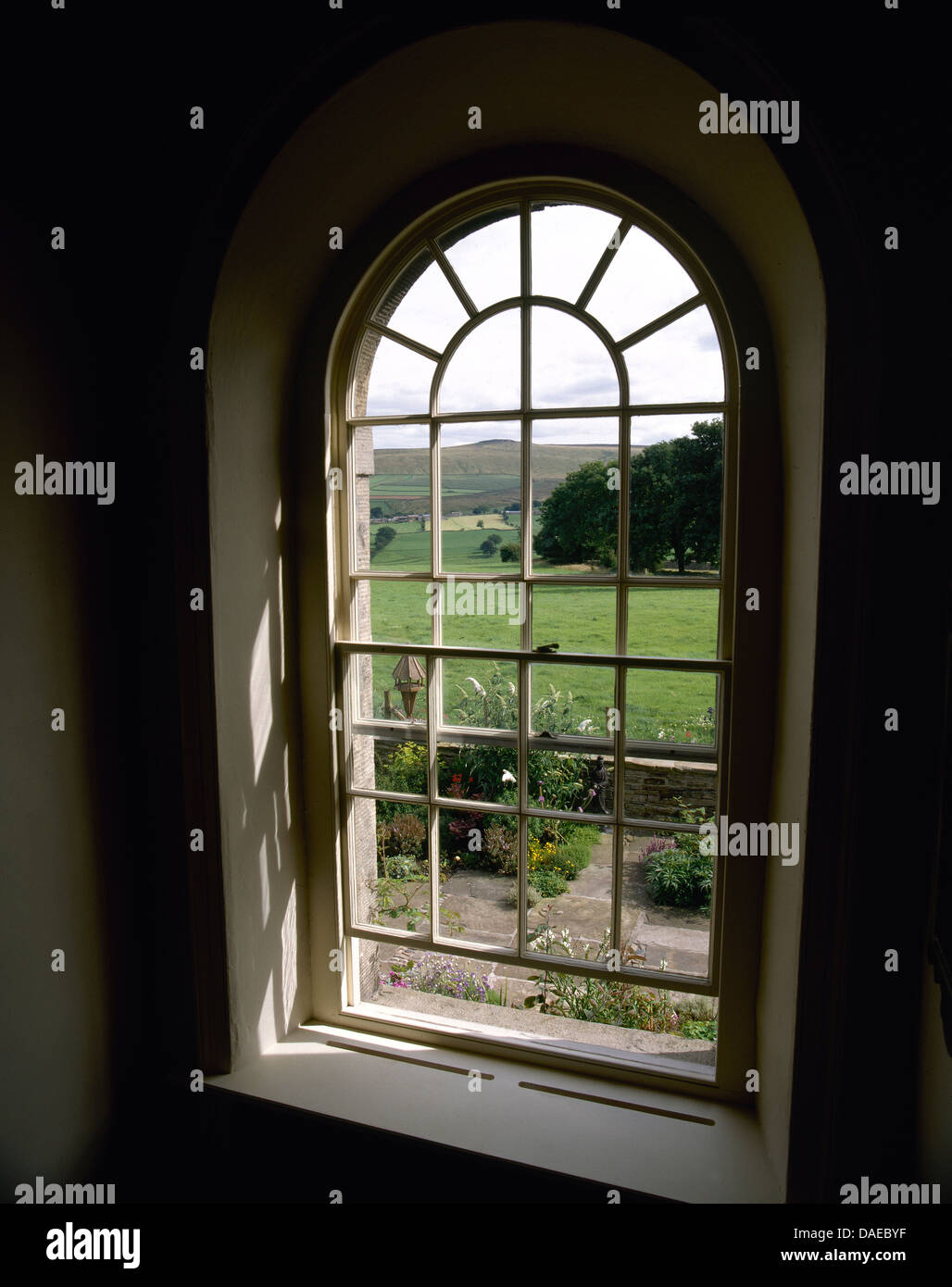 View through an arched window to garden Stock Photo - Alamy