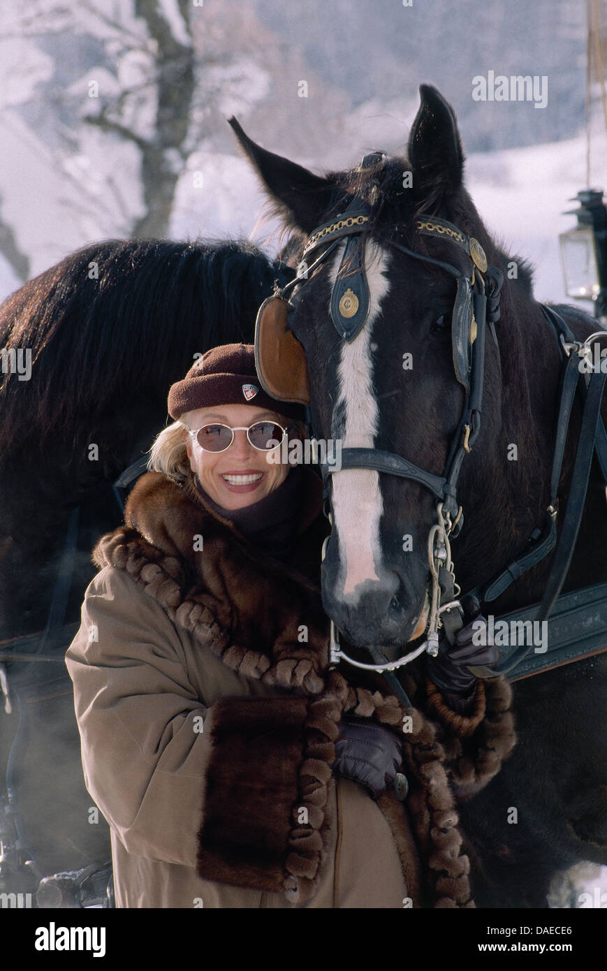 Woman standing beside horse hi-res stock photography and images - Alamy