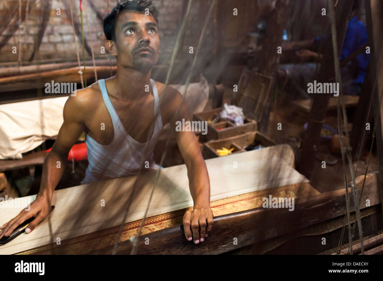 A man operates the loom making Jamdani sari in Mirpur Benarashi Palli ...