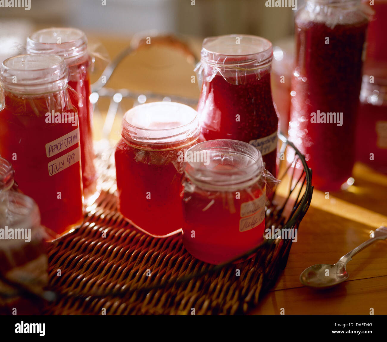 Cane tray with glass jars with jams and preserves Stock Photo - Alamy