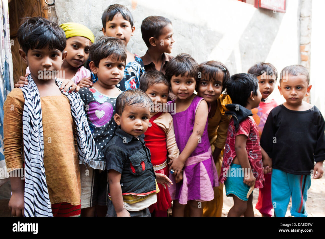 A group of children gather in Mirpur Benarashi Palli, Dhaka, Bangladesh ...
