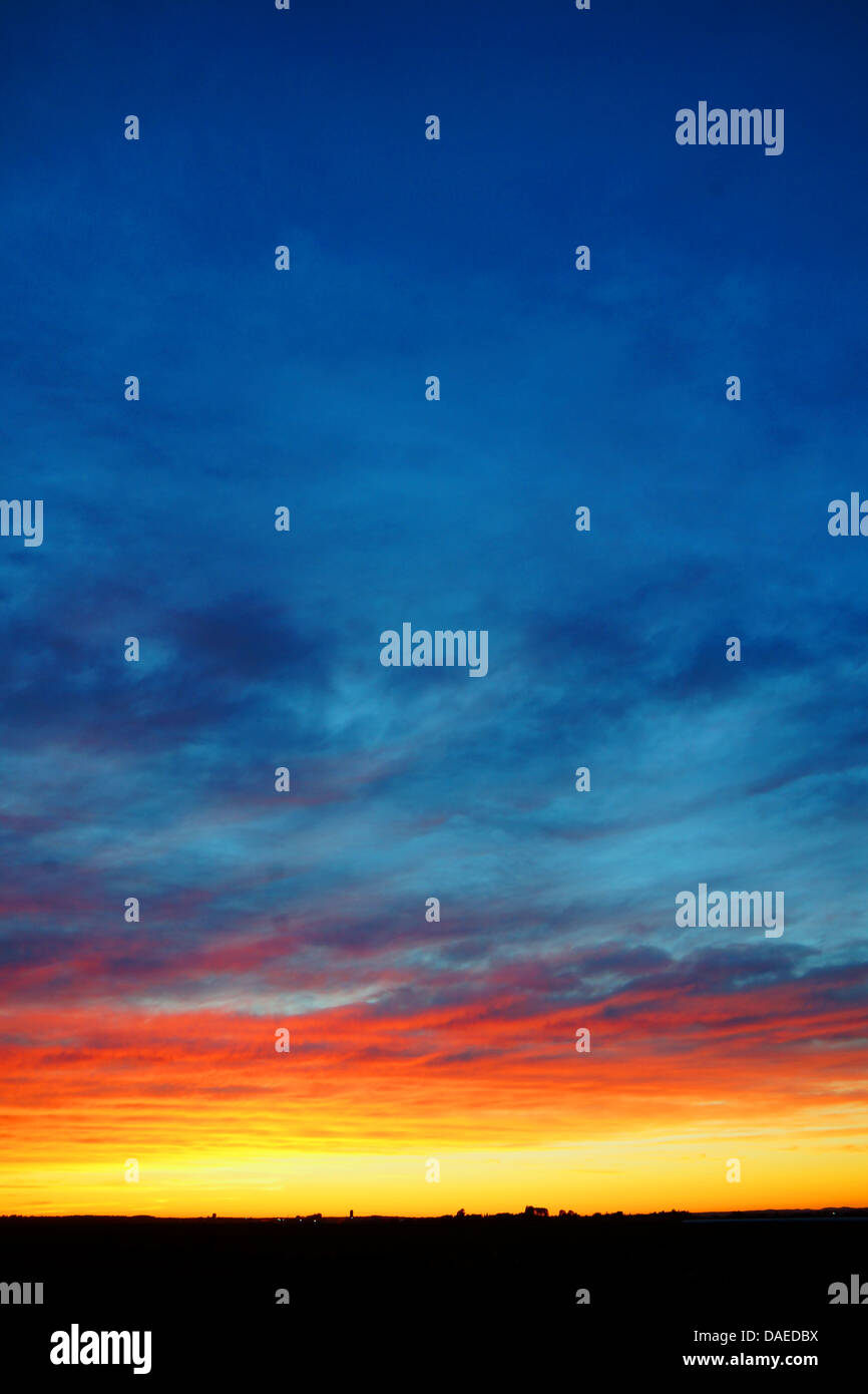 Vertical of beautiful colorful sunset over land Stock Photo - Alamy