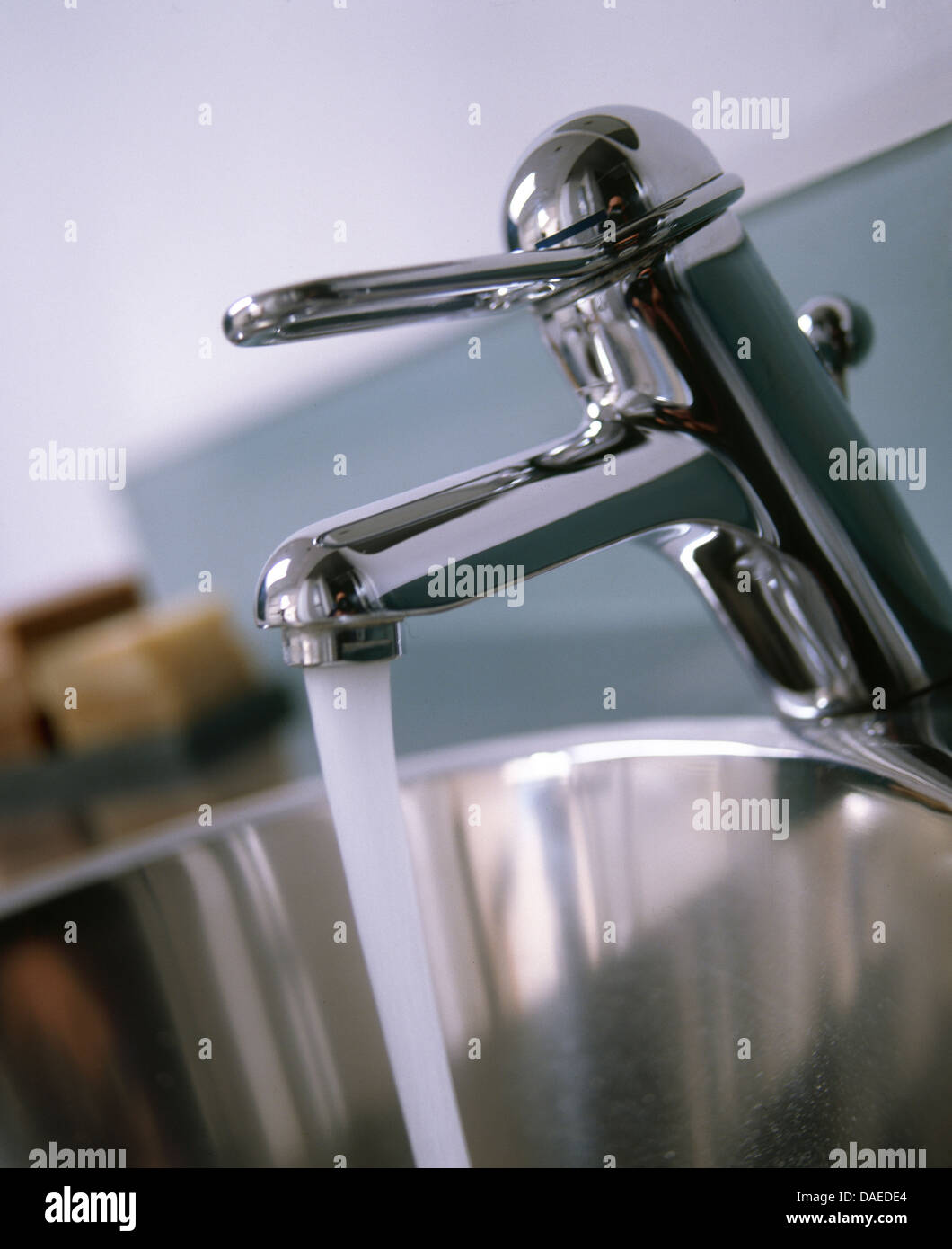 Close-up of water pouring from modern chrome tap Stock Photo - Alamy