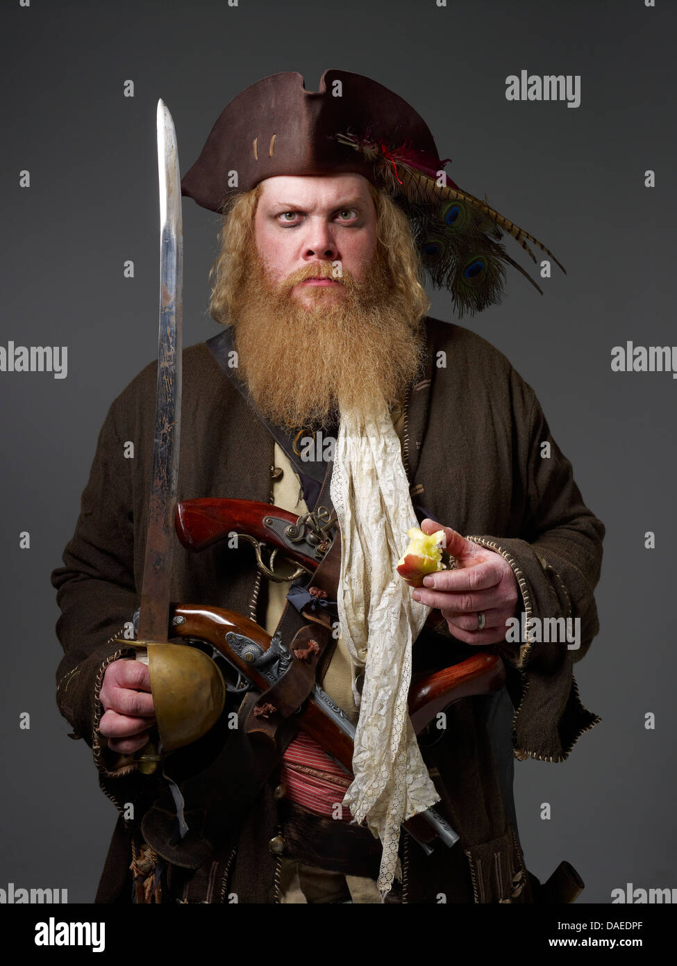 Pirate Holding Sword and Apple Core Stock Photo - Alamy
