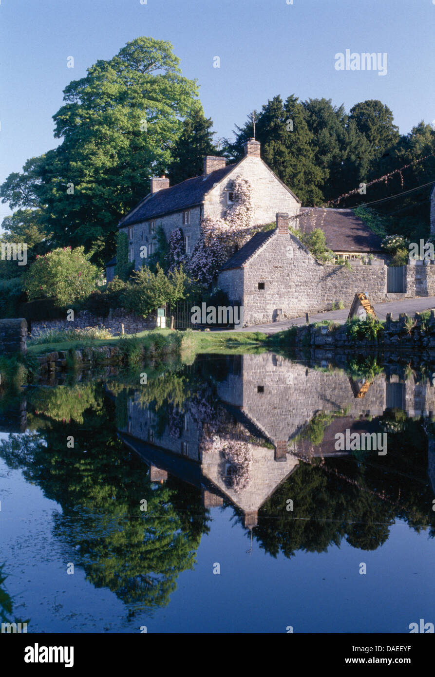 Exterior of country house seen across lake Stock Photo - Alamy
