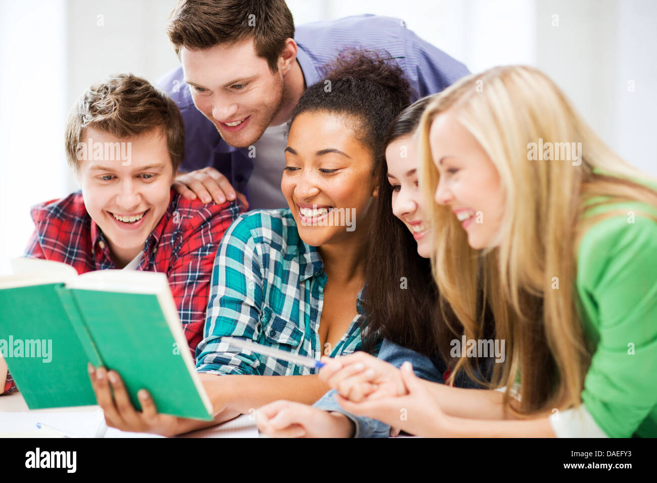 students reading book at school Stock Photo - Alamy