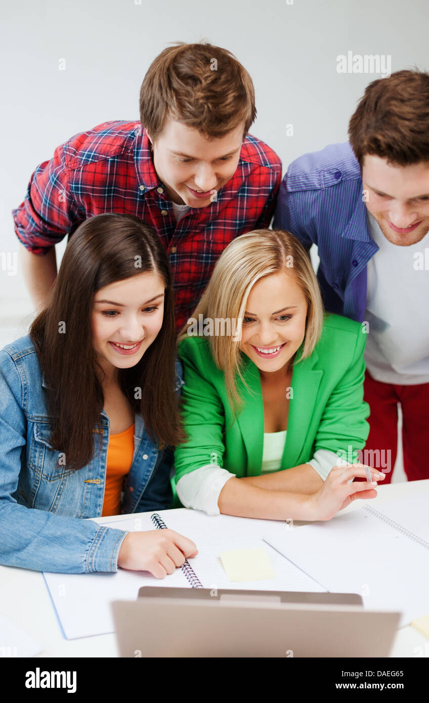 smiling students looking at laptop at school Stock Photo - Alamy
